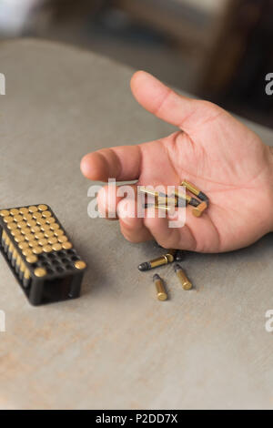 A close up of a hand gun with bullets and a magazine Stock Photo - Alamy
