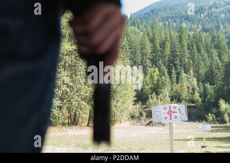 man with a gun ready to shoot (focus on the weapon Stock Photo - Alamy