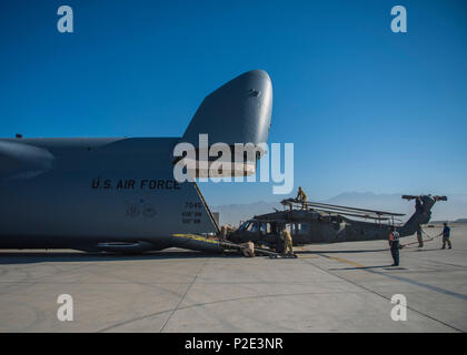 A Sikorsky UH-60 Blackhawk is hauled into a C-5 Galaxy for transport ...