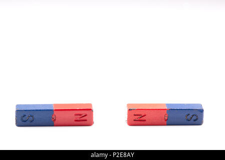 Two magnets attracting each other isolated on a white background. North ...