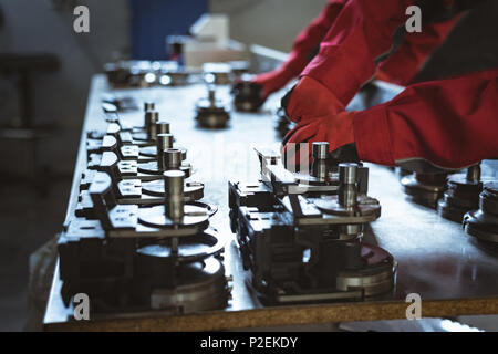 Two workers checking machine parts Stock Photo - Alamy