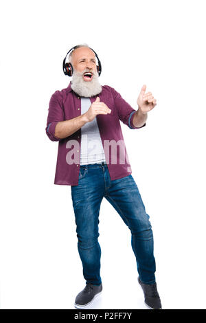 senior bearded man dancing and singing while listening music with ...