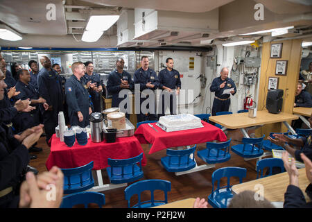 Mess SPECIALIST 3rd Class Ken Thomas pours tomato sauce into a chili ...