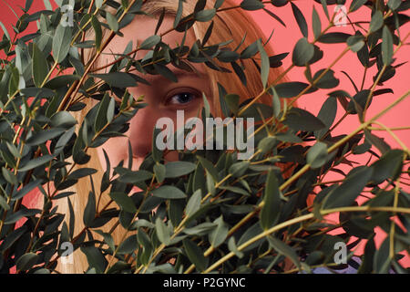 young girl hiding behind a bush Stock Photo - Alamy