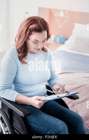 Happy crippled woman working at home Stock Photo - Alamy
