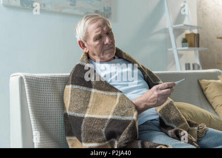 senior man checking body temperature with thermometer Stock Photo - Alamy