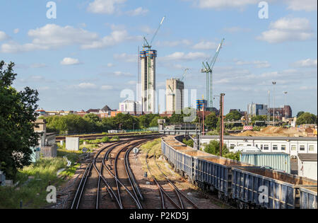 The changing skyline of Woking, Surrey: railway tracks lead into tower ...