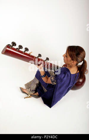 Young female musician playing Sitar at home Stock Photo - Alamy