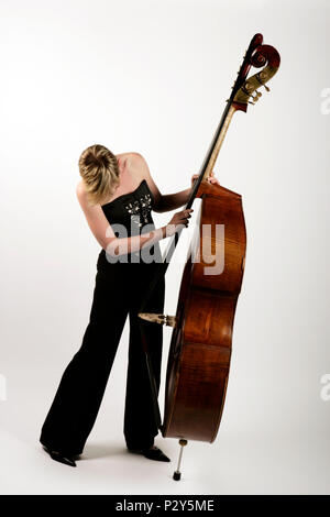 Young female double bassist with her instrument Stock Photo - Alamy