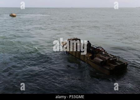 Two LARC-5 amphibious resupply cargo lighters head ashore during the ...