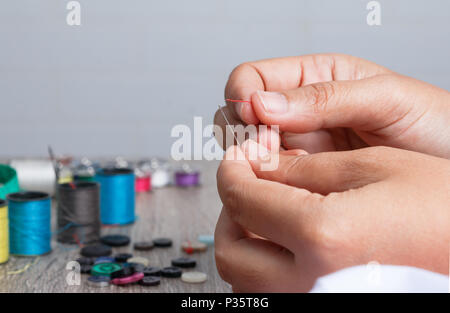 hand holding needle and thread Stock Photo: 28280624 - Alamy