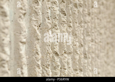 Closeup of the wall with a decorative plaster vertical lines and ...