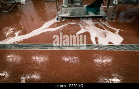 Water overflowing from industrial tank Stock Photo - Alamy