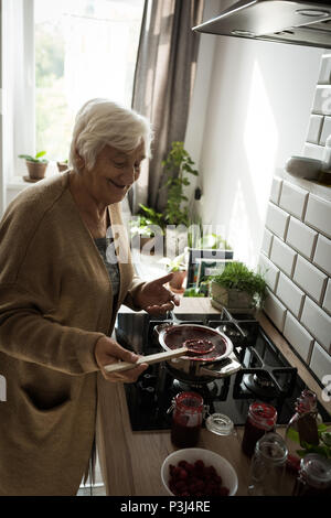 Woman cooking in kitchen. Real people, authentic, no face Stock Photo ...