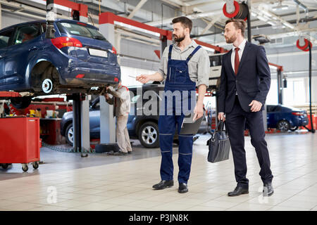 Worker Giving Tour of Factory Stock Photo - Alamy