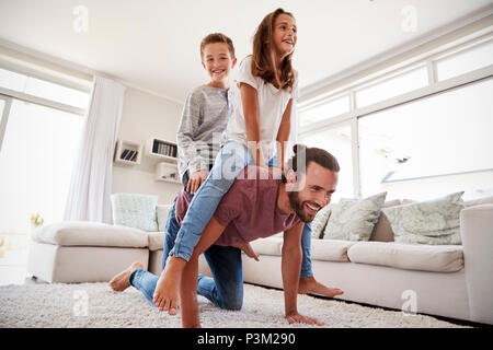 Father and son roughhousing at home in the living room Stock Photo - Alamy