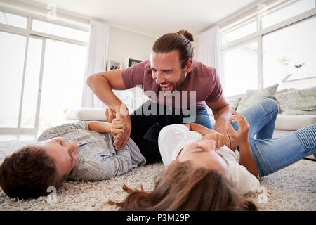 Father and son roughhousing at home in the living room Stock Photo - Alamy