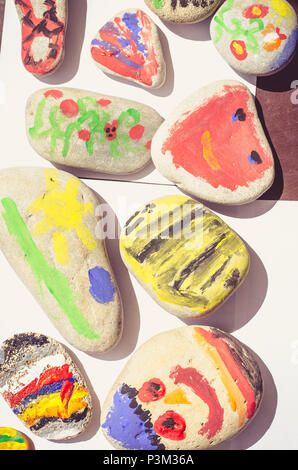 group of pebbles with bright paintings and colors Stock Photo - Alamy