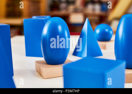 Wood Montessori geometrical blue solid volume set Stock Photo - Alamy