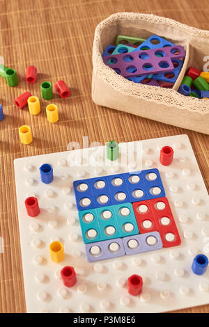 Colorful numicon game set with basket full of pieces Stock Photo - Alamy