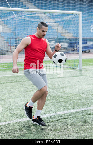 Muscular man with football ball Stock Photo - Alamy
