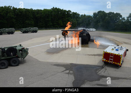 National Guard Soldiers and Airmen spray water from a fire truck turret ...