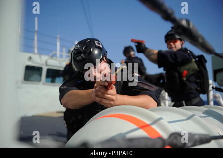 Royal Navy. A seaman from a boarding party carries a machine gun Stock ...