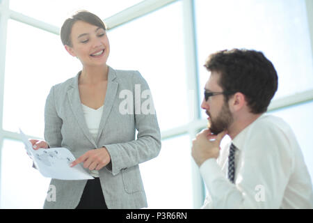 Two employees discuss work information Stock Photo - Alamy