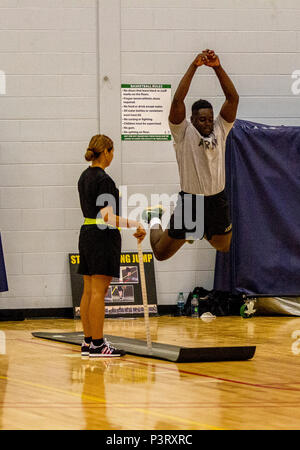 Army Reserve instructor from Task Force Wolf grades a Cadet performing the seated power throw ...