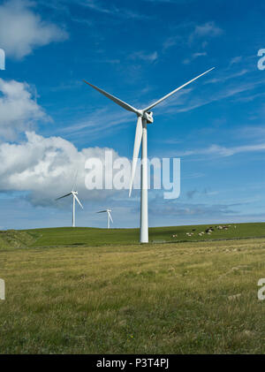Three wind turbine towers on the rocky hillside, above the town and the ...