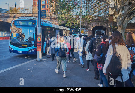 School bus in the early morning making a stop to pick up students ...