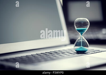 Deadline and time is money concept with hourglass and US coins currency ...