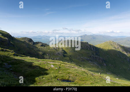 A scenic view of Loch Lomond in valley surrounded by rocky mountains ...
