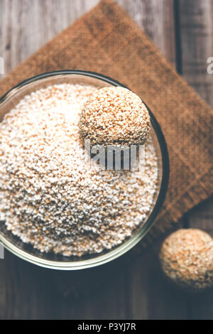 Amaranth or rajgira lahi in a bowl with sweet laddu. selective focus ...