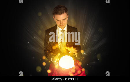 Gorgeous businessman sitting with sparkling magic ball in his lap Stock ...