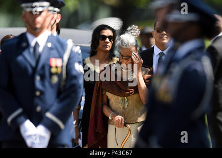 Nola Whitfield, wife of 2nd Lt. Malvin G. Whitfield, hugs the U.S. flag ...