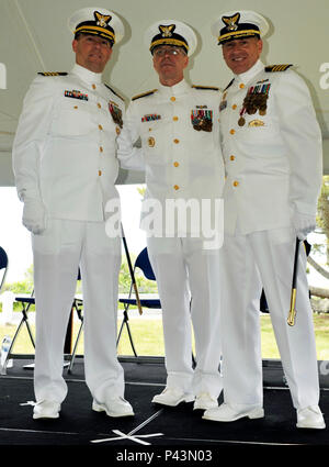 Rear Adm. Steven D. Poulin, commander of First Coast Guard District, speaks with Lt. Cmdr. Dale ...