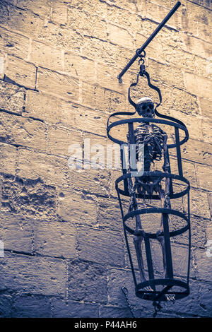 Metal cage and human skeleton in the Torture Room in the cellars of La ...