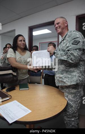 U.S. Army Lt. Col. Derrell Martin, Task Force Red Wolf Commander, cuts ...