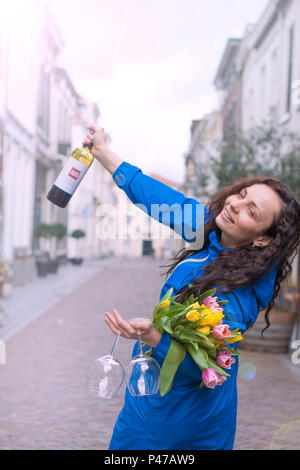fashion girl in red raincoat posing near old wooden fence by evening ...