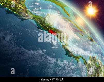 Sunrise above El Salvador highlighted in red on model of planet Earth in space with visible ...