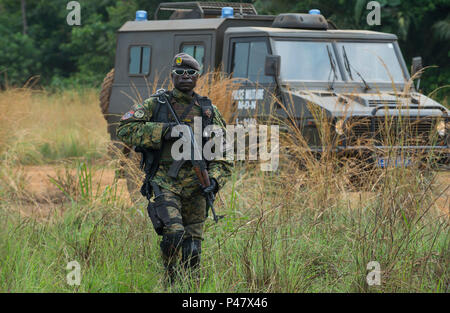 A member of the Gabonese Military Police provides security for several ...