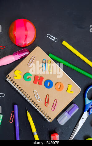Flat lay with lettering back to school and set of school equipment on ...