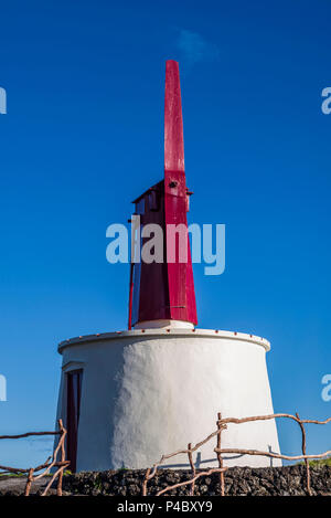 The windmill of Urzelina, Sao Jorge Island, Azores, is located next to ...