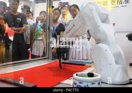 A robot writes calligraphy in Zoucheng, east China's Shandong Province ...
