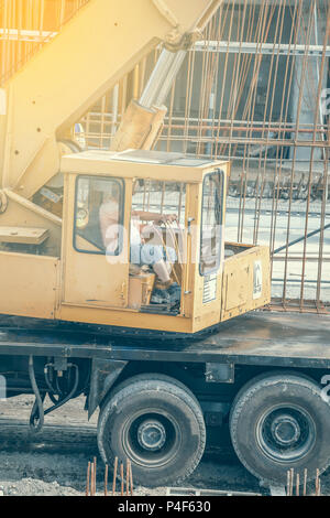 Mobil crane lifting cabin, controlling a machine that holds thousand ...