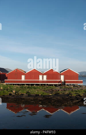 Traditional red wooden norwegian cabins with ground on the roof ...