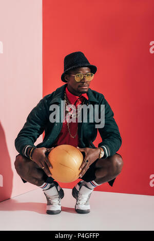 African American male model crouching like a gangster isolated on white ...