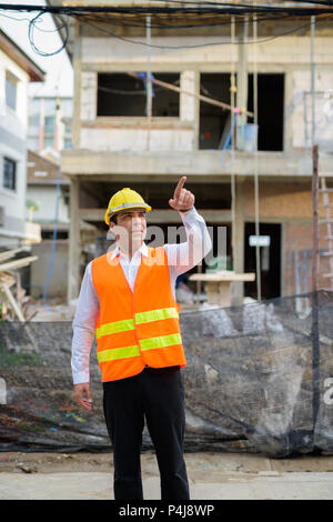 Handsome Persian man construction worker at the construction site at ...