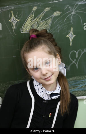 Portrait of small cheerful pupil pretty lady arms hold giftbox red ...